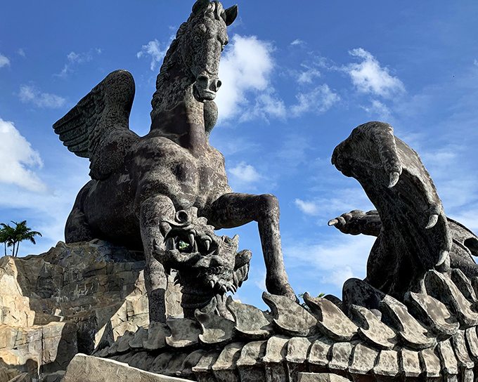 The epic showdown between Pegasus and Dragon unfolds in bronze and stone, like mythology's greatest heavyweight match frozen in time.