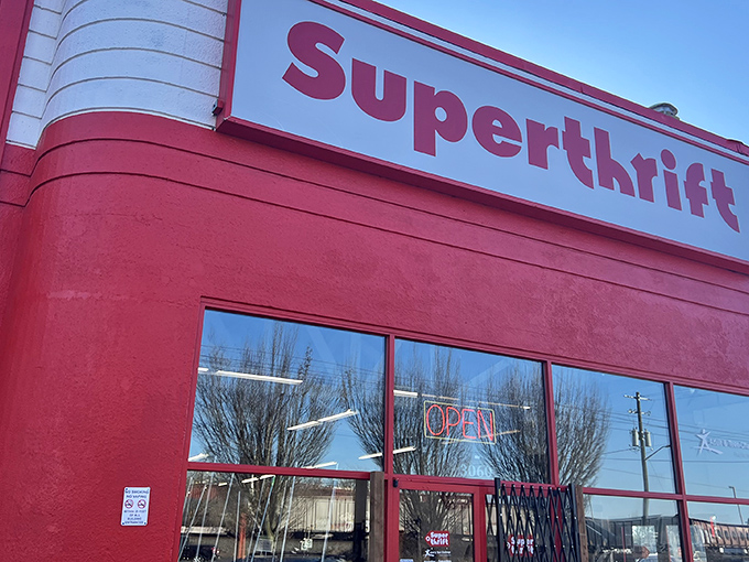 The bright red exterior of SuperThrift beckons like a siren call to bargain hunters, promising treasures within those unassuming walls.