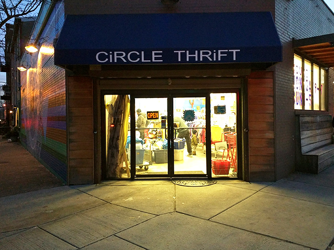 The iconic blue awning of Circle Thrift glows like a beacon for treasure hunters as dusk settles over Philadelphia, promising adventures in secondhand splendor.