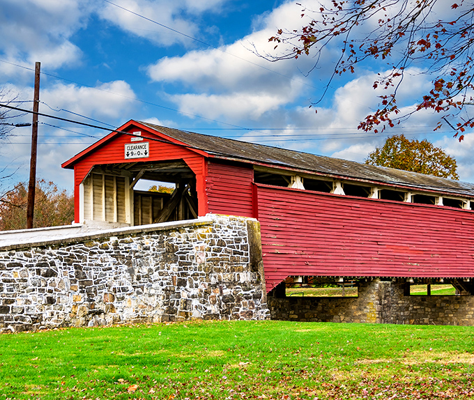 Standing proud since 1841, the Wehr Covered Bridge flaunts its crimson coat against Pennsylvania's blue skies like it's auditioning for a Norman Rockwell painting.