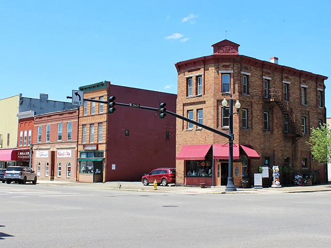 Downtown Coshocton from above, where a bright yellow train cuts through the heart of town like a cheerful messenger from another era.