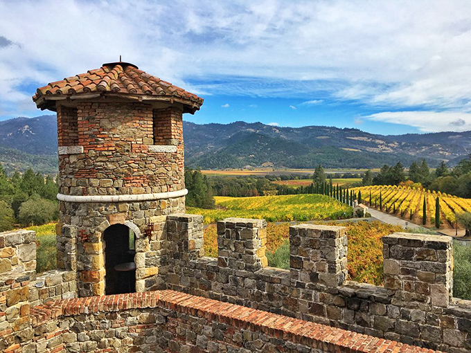 The imposing stone facade of Castello di Amorosa stands against the California sky, looking like it was plucked straight from a Tuscan hillside and dropped into Napa Valley.