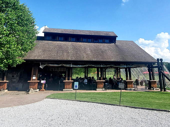 The rustic barn exterior of Sarah's Vineyard welcomes visitors with its weathered wood charm and inviting outdoor seating&mdash;Napa Valley spirit with heartland hospitality.