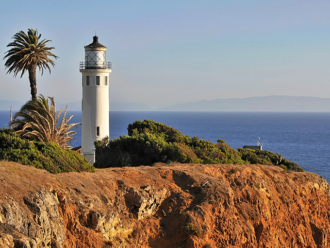 The iconic white tower stands sentinel against the blue Pacific, a postcard moment that's been guiding sailors and dazzling visitors for generations.