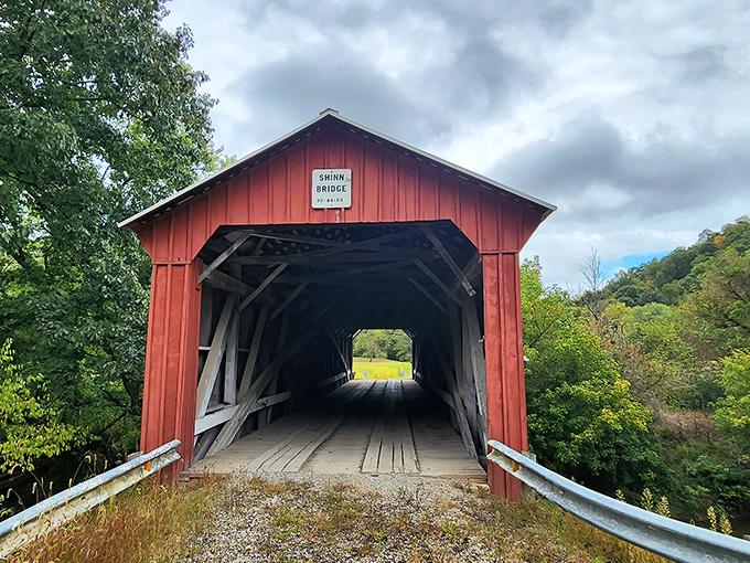 The crimson facade of Shinn Bridge stands like a portal to another era, inviting travelers to step back in time while crossing Wolf Creek.