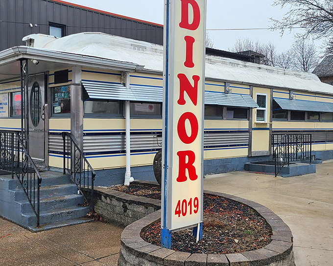 The classic "DINOR" sign beckons like a neon lighthouse, promising comfort food and conversations in this vintage Erie treasure.