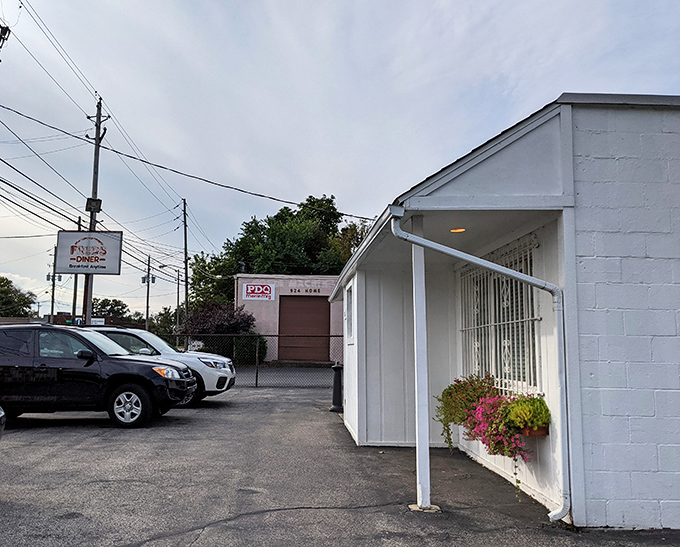 The unassuming white exterior of Fred's Diner proves once again that culinary treasures often hide in plain sight. Those flower boxes are your first clue to the warmth waiting inside.