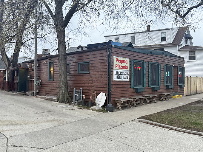 The unassuming wooden exterior of Pequod's Pizza hides culinary greatness like a superhero's secret identity. Pizza paradise in cabin form.