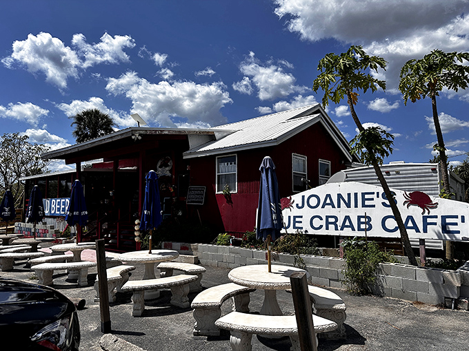 Like a red mirage rising from the Everglades, Joanie's welcomes wanderers with concrete picnic tables and the promise of authentic Florida flavors that no theme park could replicate.