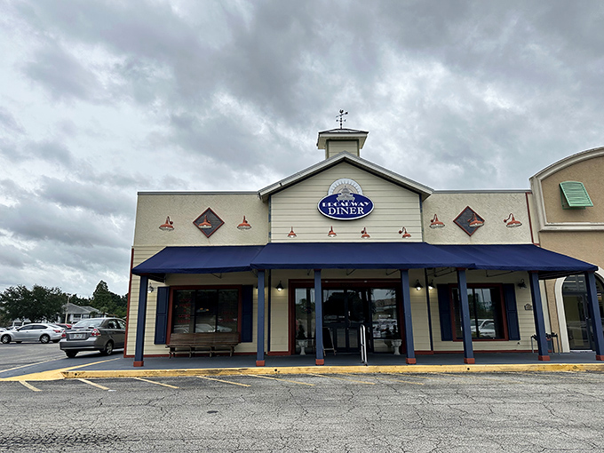 The welcoming facade of Broadway Diner in Bartow beckons with its classic blue awning and warm lighting&mdash;like a culinary lighthouse for hungry travelers.