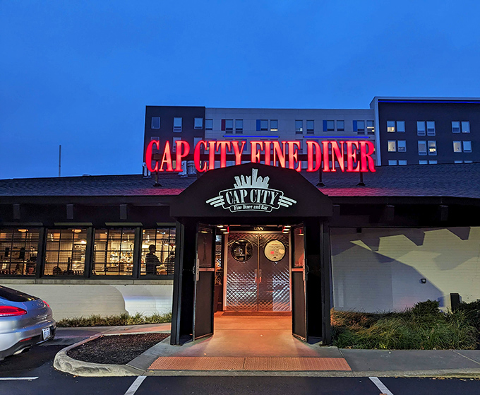 The neon glow of Cap City's sign against the twilight sky isn't just illumination&mdash;it's a beacon calling hungry souls home to comfort food paradise.