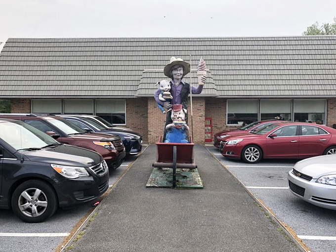 The sign says "Authentic Amish Cooking," but that whimsical statue out front tells you this place has personality beyond the expected bonnets and buggies.