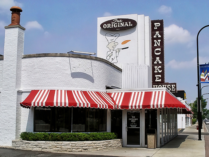The iconic red and white awning of Walker Bros. beckons like a breakfast lighthouse guiding hungry souls to pancake paradise.