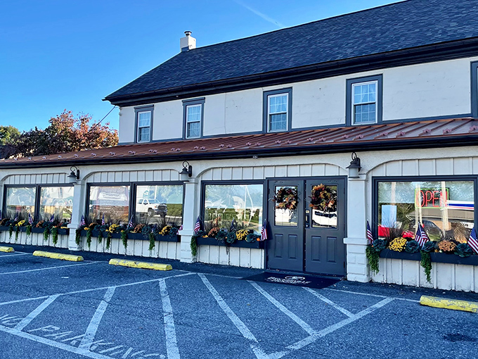 The Brickerville House stands proudly against the Pennsylvania sky, its flower boxes and American flags offering a warm welcome before you even reach the door.