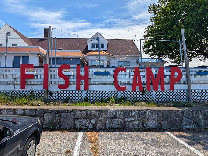 The bold red "FISH CAMP" sign against the white building is like a lighthouse for hungry souls&mdash;guiding seafood pilgrims to their delicious destination.