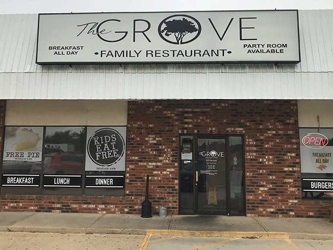 The unassuming brick facade of The Grove Family Restaurant hides culinary treasures within. That "FREE PIE" sign isn't just decoration&mdash;it's a promise of sweet things to come.