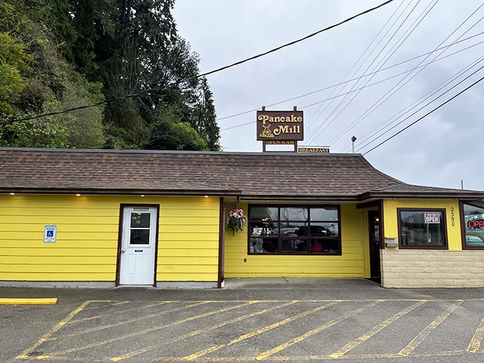 The sunshine-yellow exterior of Pancake Mill stands out like a beacon of breakfast hope on Oregon's coast, promising carb-laden comfort to weary travelers.