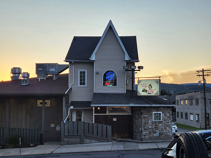 The storybook-meets-stonework exterior of Jack & Georges stands like a culinary lighthouse, beckoning hungry travelers with its distinctive peaked roof and rustic charm.