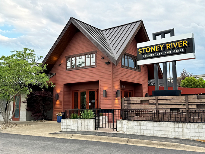 The A-frame exterior of Stoney River glows like a beacon for hungry travelers, promising mountain lodge comfort with Nashville sophistication.