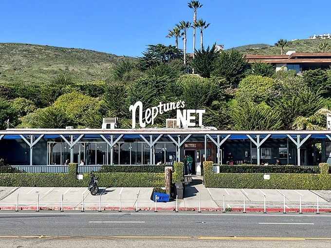 Neptune's Net stands proudly along PCH, a blue-trimmed beacon for hungry travelers and motorcycle enthusiasts alike. The California sun practically high-fives the iconic signage.