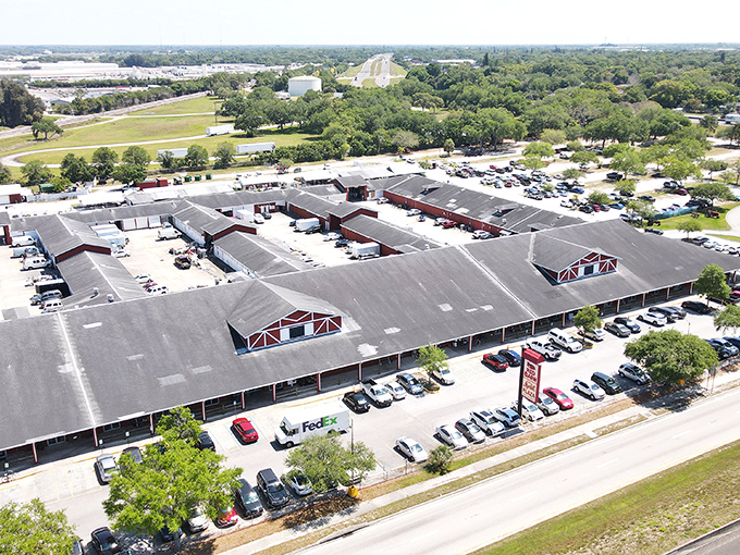 From above, the Red Barn sprawls like a treasure-hunting kingdom, its distinctive red-trimmed roofline promising adventures within. Florida's ultimate "I didn't know I needed that" destination.
