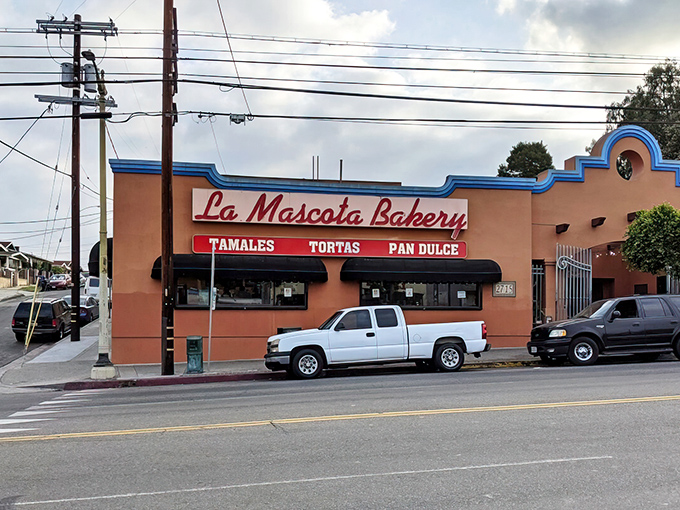 The salmon-colored exterior with bright blue trim isn't just a building&mdash;it's a beacon of culinary promise that's drawn tamale enthusiasts for generations.
