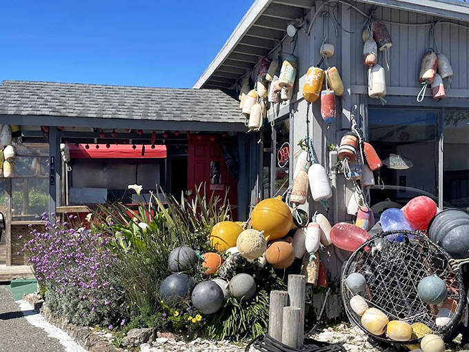 Maritime charm at its finest! The Boat House's weathered exterior adorned with colorful buoys isn't designer-crafted coastal&mdash;it's the real seafaring deal.