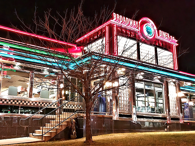 The Broadway Diner glows like a neon dream against the night sky, a beacon of comfort food that's been saving hungry Baltimoreans from themselves for generations.