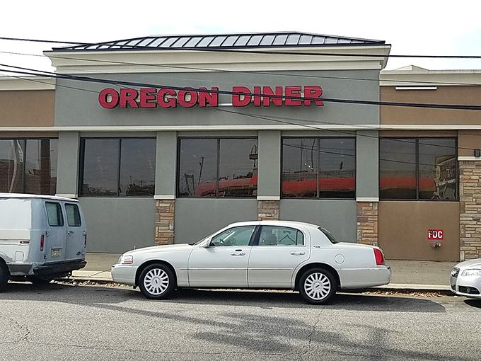 The iconic Oregon Diner sign stands proud against the Philly sky, a beacon of breakfast hope for hungry souls seeking salvation in syrup.
