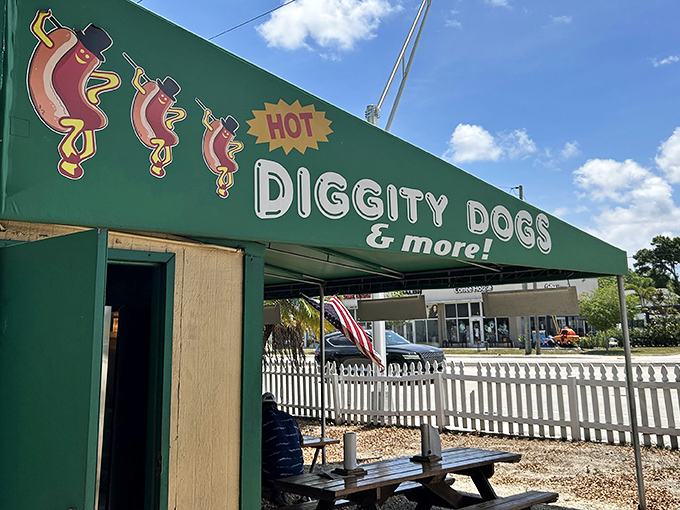 The emerald green awning of Hot Diggity Dogs beckons like a culinary lighthouse, promising simple pleasures and picnic table perfection.