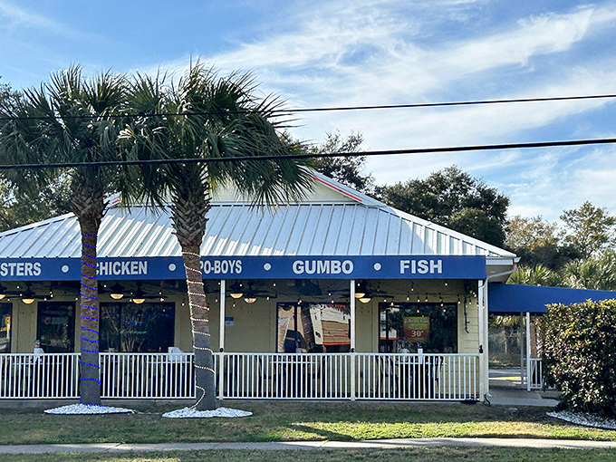 The blue awnings of Shrimp Basket beckon like a seafood siren call, promising oysters, chicken, po-boys, gumbo, and fish under one cheerful roof.