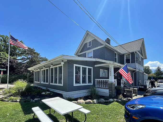 Jake's On Lake glows with welcoming warmth at dusk, its charming gray exterior and accessible entrance promising comfort before you even step inside.