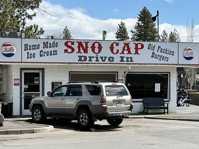 The classic white facade of Sno Cap Drive In stands like a time capsule in Sisters, Oregon, promising homemade ice cream and old-fashioned burgers that deliver on every nostalgic bite.v
