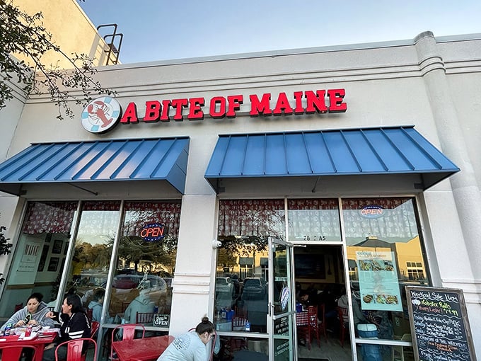 The bright red sign against the blue awning is like a lighthouse beacon for seafood lovers lost in a sea of chain restaurants.