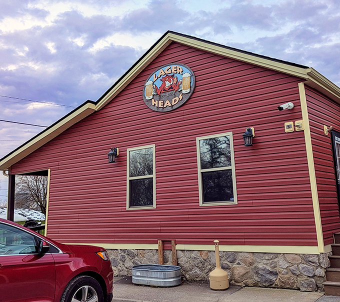 The bright red exterior of Lager Heads stands like a beacon for barbecue pilgrims, promising smoky treasures within those humble walls.