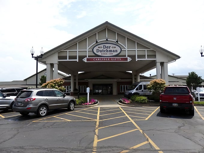 The welcoming entrance to Der Dutchman stands like a culinary lighthouse, beckoning hungry travelers with promises of Amish comfort food that'll make your cardiologist wince and your soul sing.