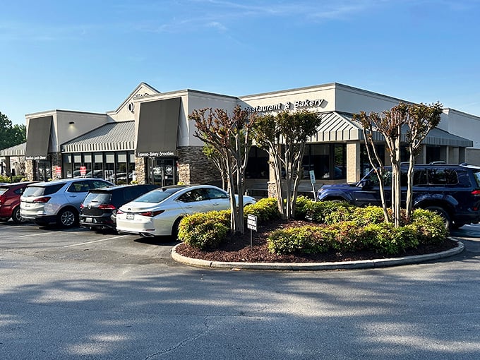 The welcoming exterior of Stax Omega beckons hungry travelers like a lighthouse guiding ships to delicious harbor in Greenville.