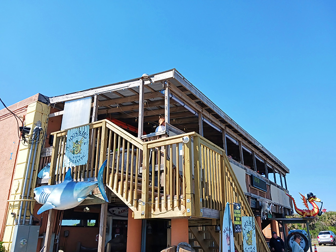 The shark might not bite, but the flavors at Lou's Blues certainly will. This weathered beach-bar exterior promises authentic Florida experiences inside.
