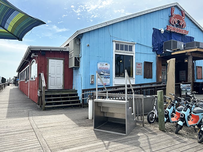 Pinchers' cheerful blue exterior beckons seafood lovers like a coastal lighthouse, promising treasures from the deep just steps from the water.