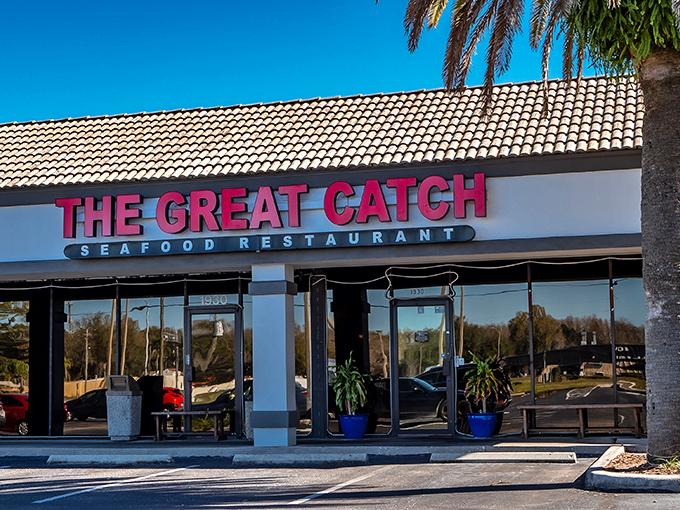 The Great Catch's bold red signage stands out like a lighthouse beacon for seafood lovers, promising New England treasures in sunny Florida.
