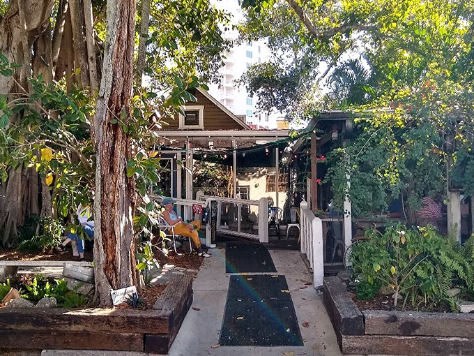 The entrance to Owen's Fish Camp feels like stepping into a Southern novel – complete with a majestic banyan tree standing guard over seafood paradise.