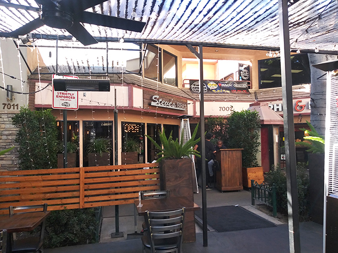 Steve's BBQ welcomes you with a cozy patio entrance that feels like the gateway to barbecue paradise. String lights and greenery create the perfect California-casual vibe.