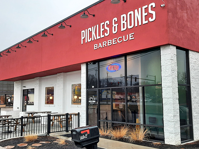 The bright red exterior of Pickles & Bones stands like a beacon of barbecue hope in Milford, promising smoky delights within those unassuming walls.