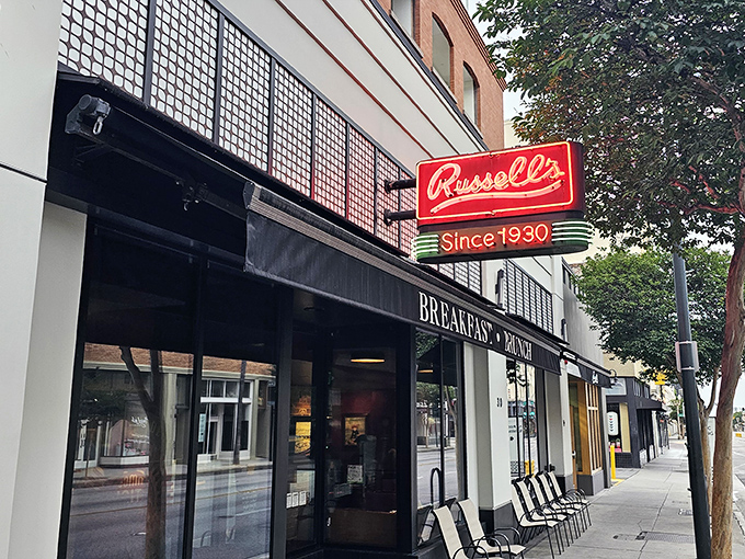 The iconic red neon sign beckons hungry Pasadenans like a breakfast lighthouse. Russell's storefront promises comfort and tradition on Fair Oaks Avenue.