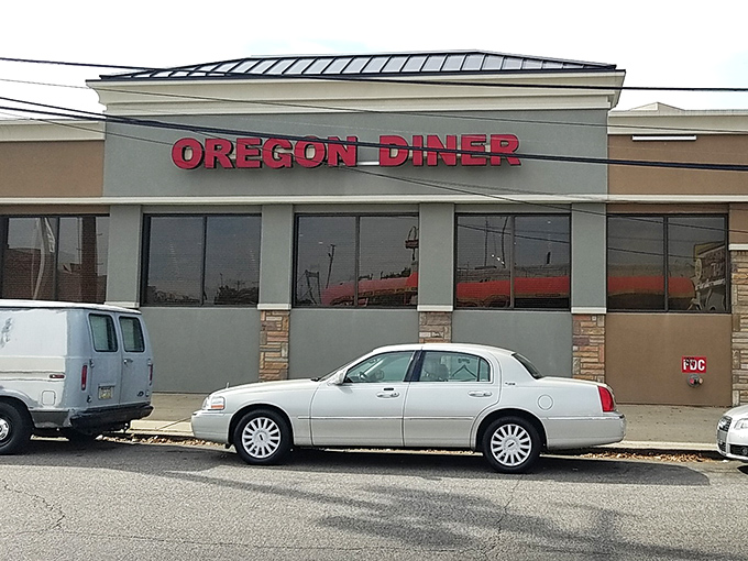 The iconic Oregon Diner sign stands proud against the Philly sky, a beacon of breakfast hope for hungry souls seeking salvation in syrup.