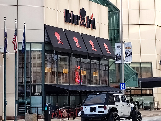 The iconic Weber kettle grill silhouettes stand guard above the entrance like sentinels of sizzle, promising smoky delights within this downtown Indy landmark.