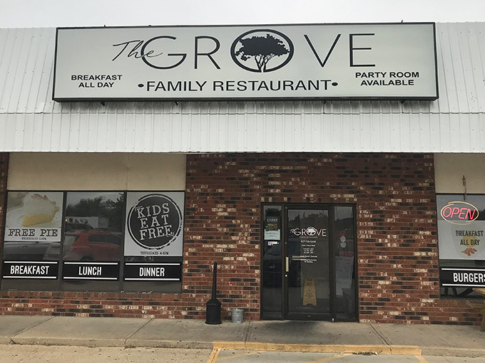 The unassuming brick facade of The Grove Family Restaurant hides culinary treasures within. That "FREE PIE" sign isn't just decoration&mdash;it's a promise of sweet things to come.