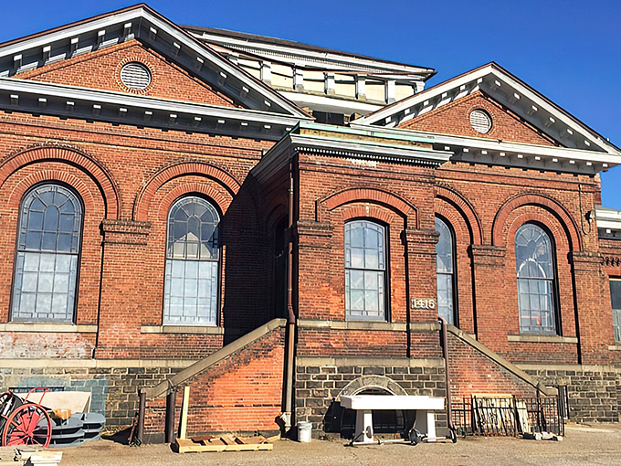 The majestic brick exterior of Housewerks stands like a Victorian time machine, its arched windows promising treasures within that modern buildings simply can't match.