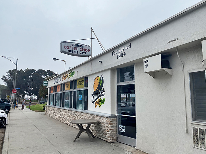 The unassuming exterior of Chuck's Coffee Shop stands as a time capsule on Ocean Boulevard, promising breakfast magic since 1964.