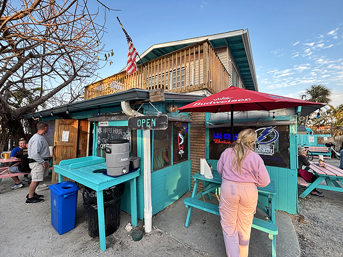The turquoise beacon of burger paradise stands proudly on Holmes Beach, where the American flag waves as if to say, "Yes, this is what freedom tastes like."